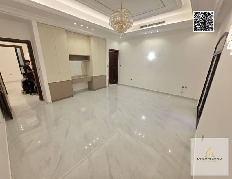 A luxurious, modern corner villa with a full stone facade and an ultra ...