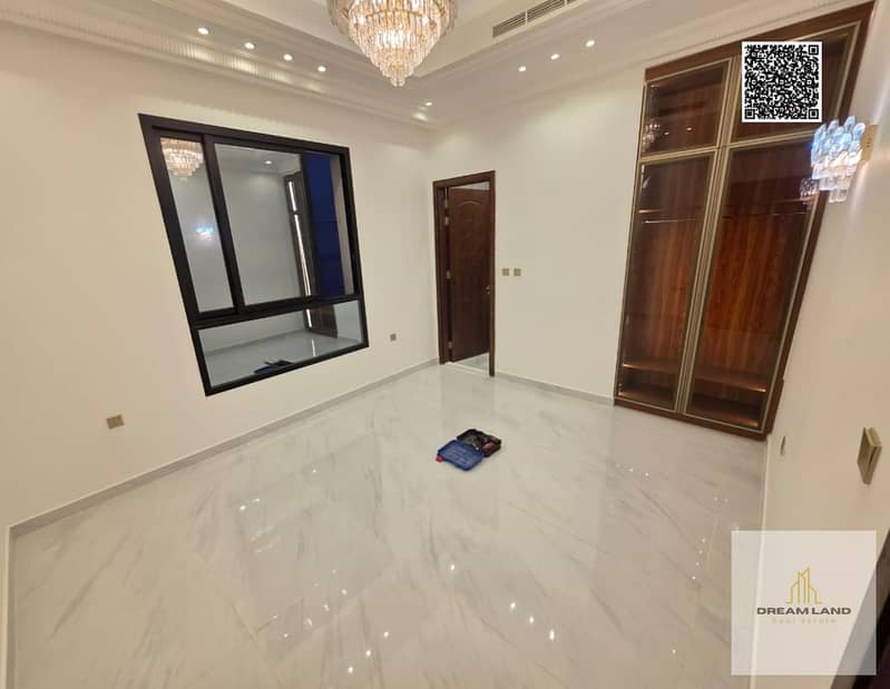 A luxurious, modern corner villa with a full stone facade and an ultra ...