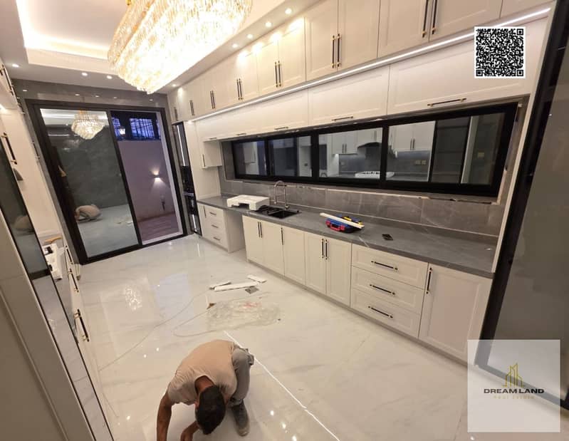 A luxurious, modern corner villa with a full stone facade and an ultra ...